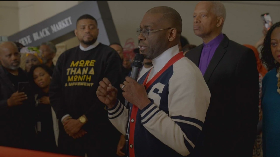 Pastor Jamal Bryant holding Bullseye Black Market in Atlanta | 11alive.com