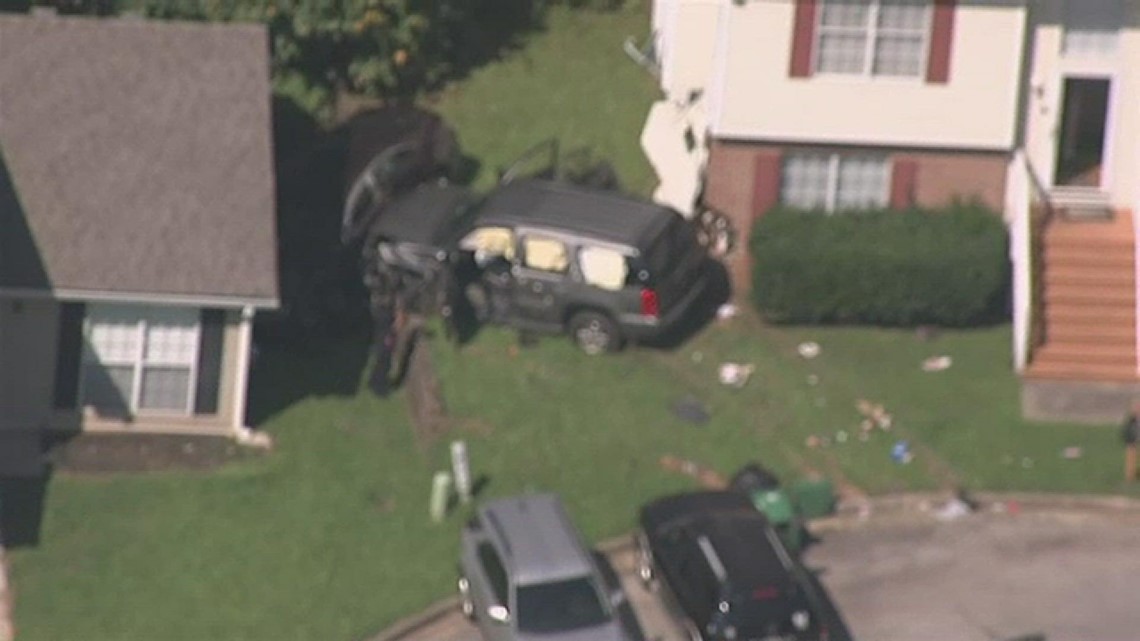 SUV riddled with bullets crashes into house after driver struck, police ...
