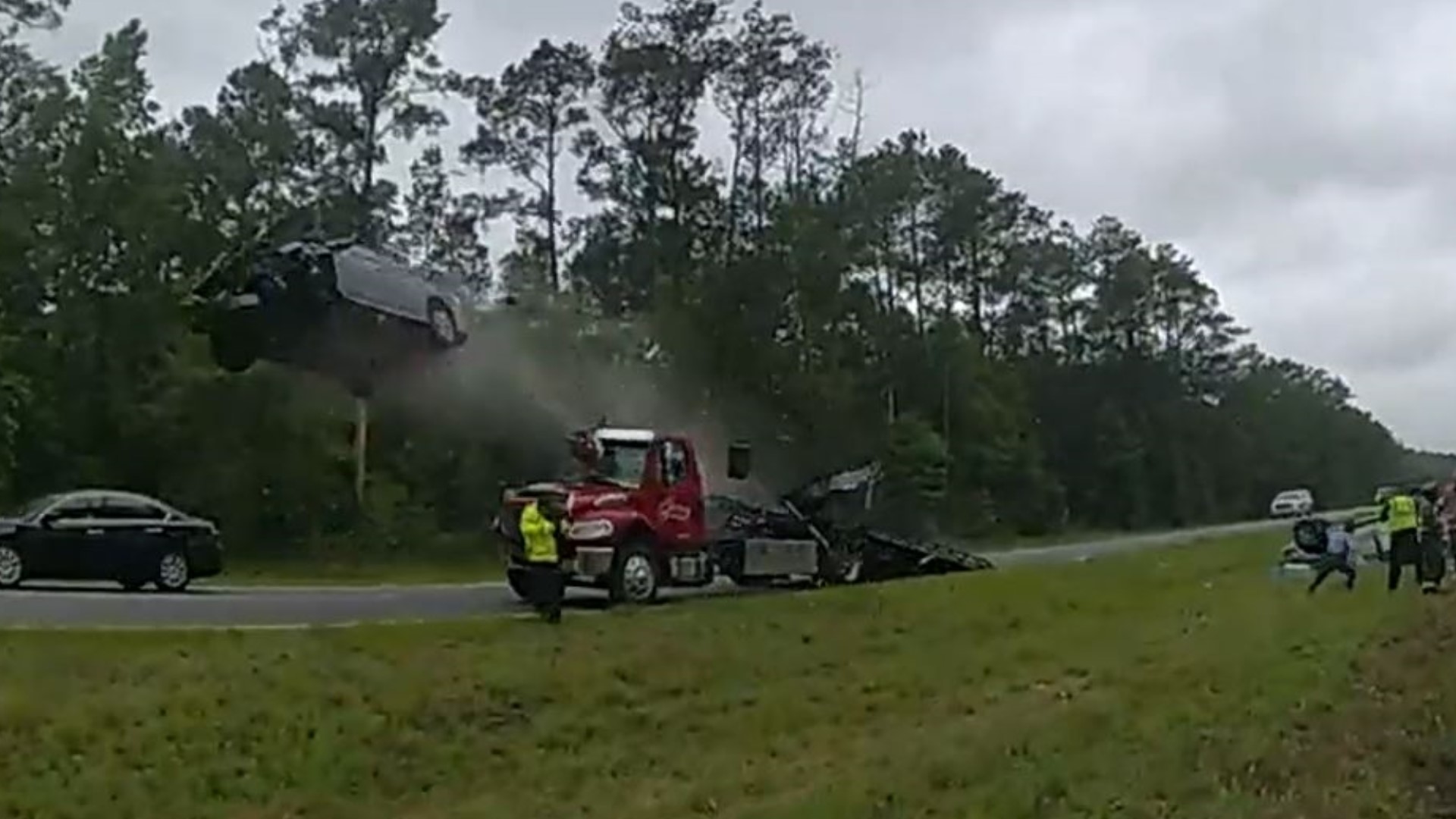 Driver sends car flying off parked tow truck ramp in front of police ...